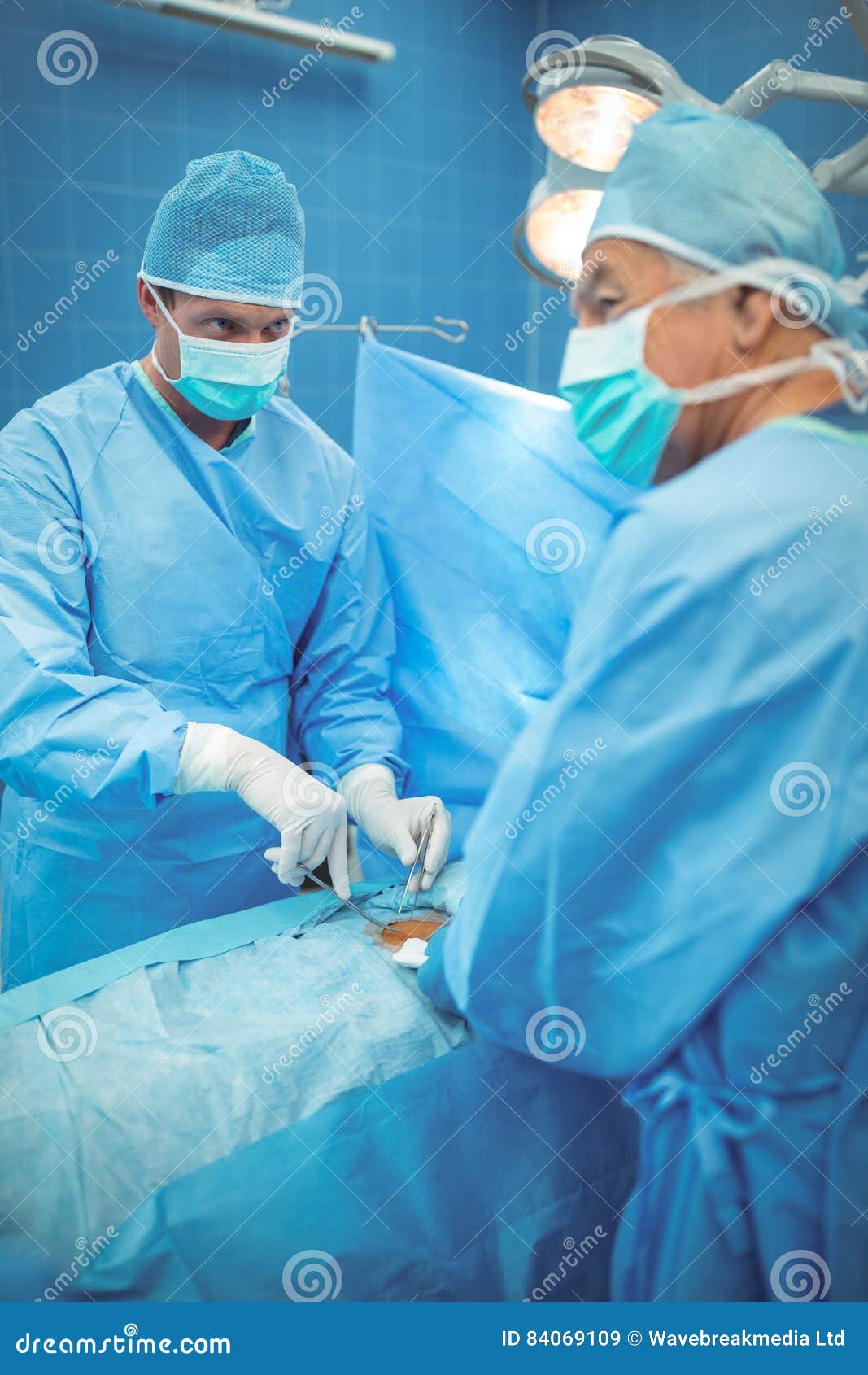Surgeon With Scalpel Performing Operation In Operation Theater Stock