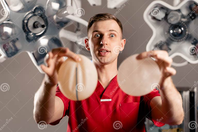 The Surgeon Shows Different Types of Silicone Implants. Breast ...