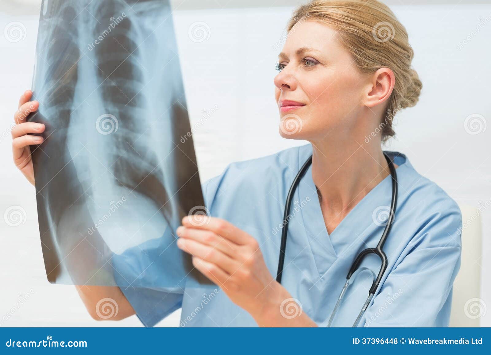 Surgeon Studying An Xray Sitting At Her Desk Royalty-Free Stock ...