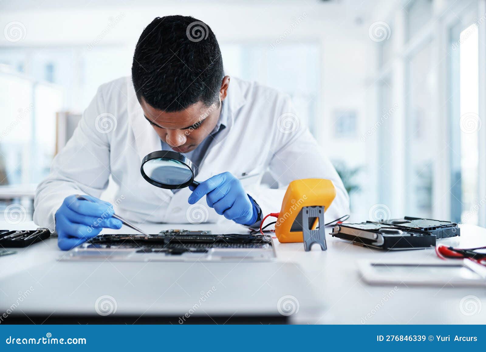 The Surgeon of it Systems. a Young Man Using Tweezers and a Magnifying ...