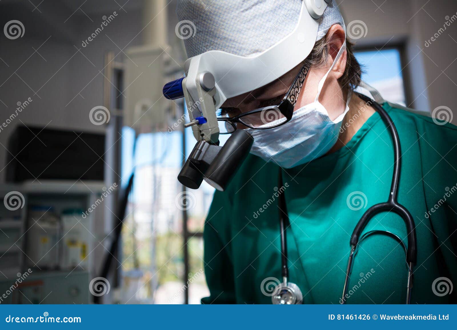 Surgeon Wearing Surgical Loupes while Operating Stock Photo - Image of ...