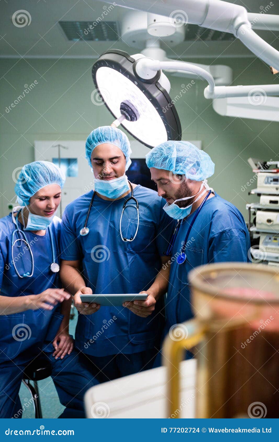 Surgeons Discussing Over Digital Tablet in Operation Room Stock Photo ...