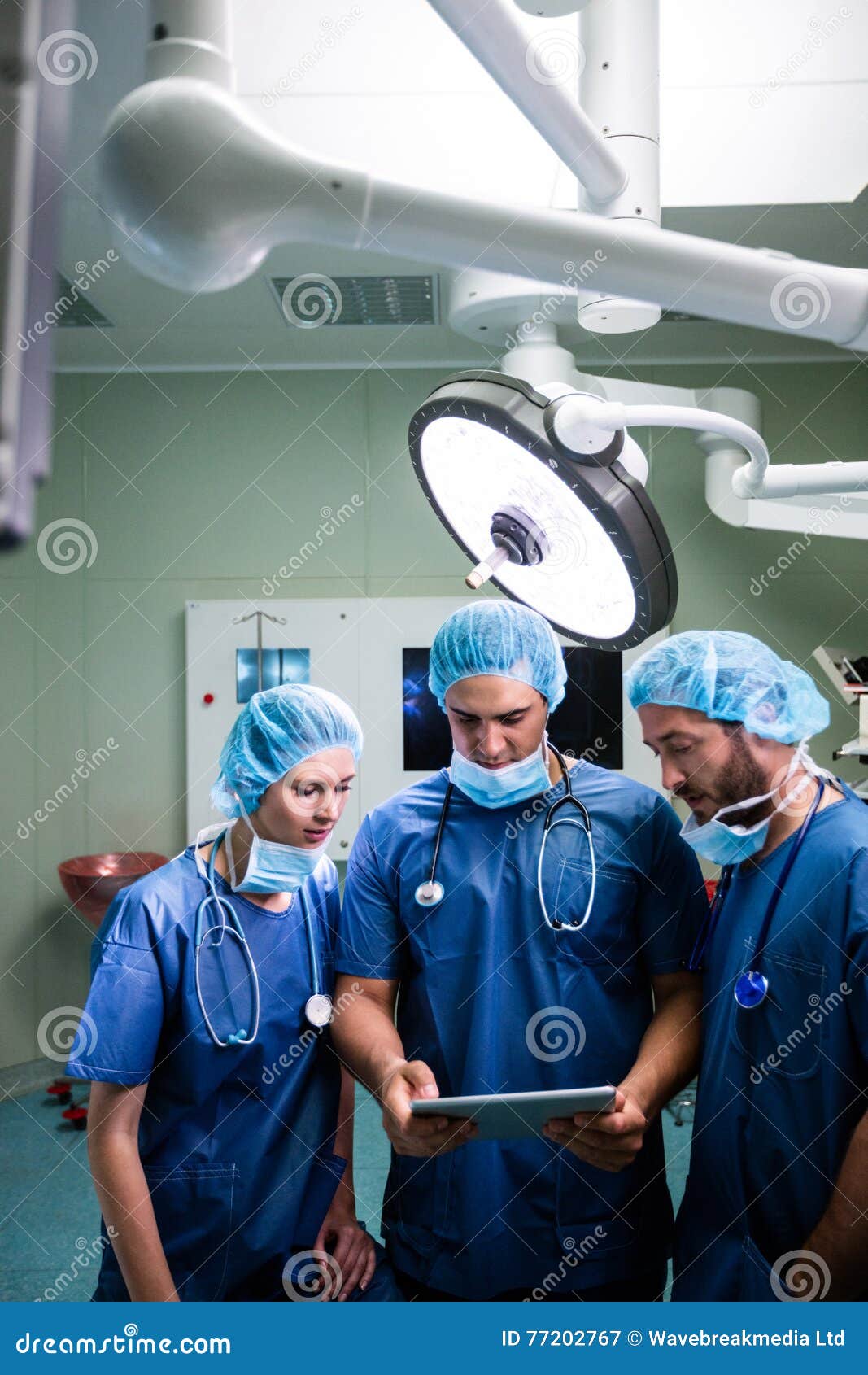 Surgeons Discussing Over Digital Tablet in Operation Room Stock Image ...