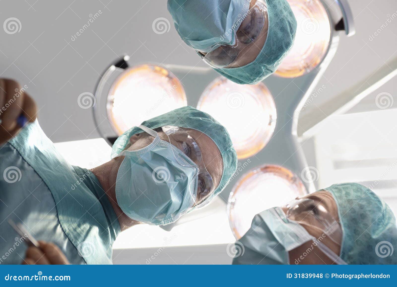 Surgeons Discussing Surgery In Operating Theatre Royalty Free Stock ...