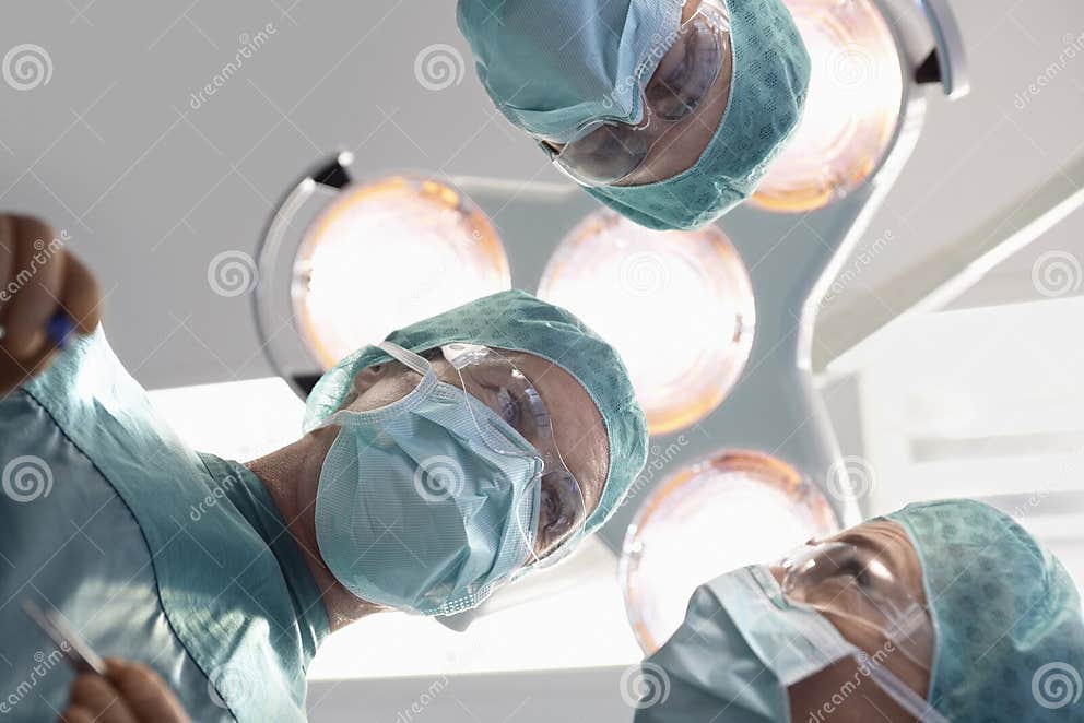 Surgeons Discussing Surgery in Operating Theatre Stock Photo - Image of ...