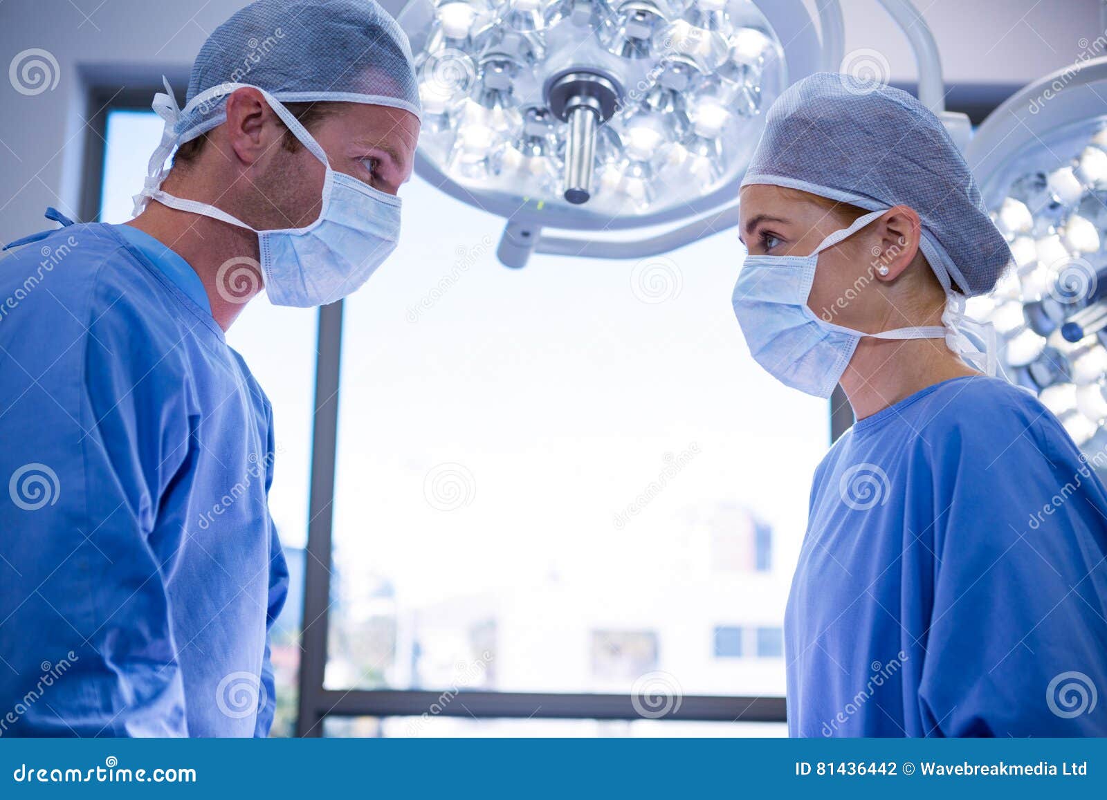Surgeons Interacting with Each Other in Operation Theater Stock Photo ...