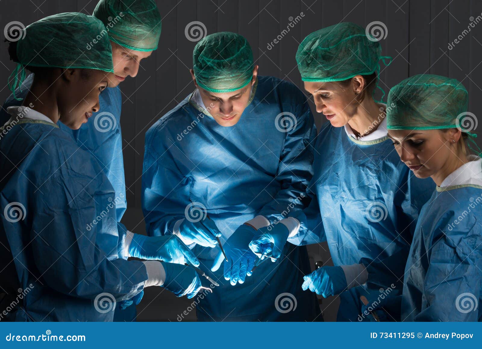 Surgeons in Operating Room stock image. Image of patient - 73411295