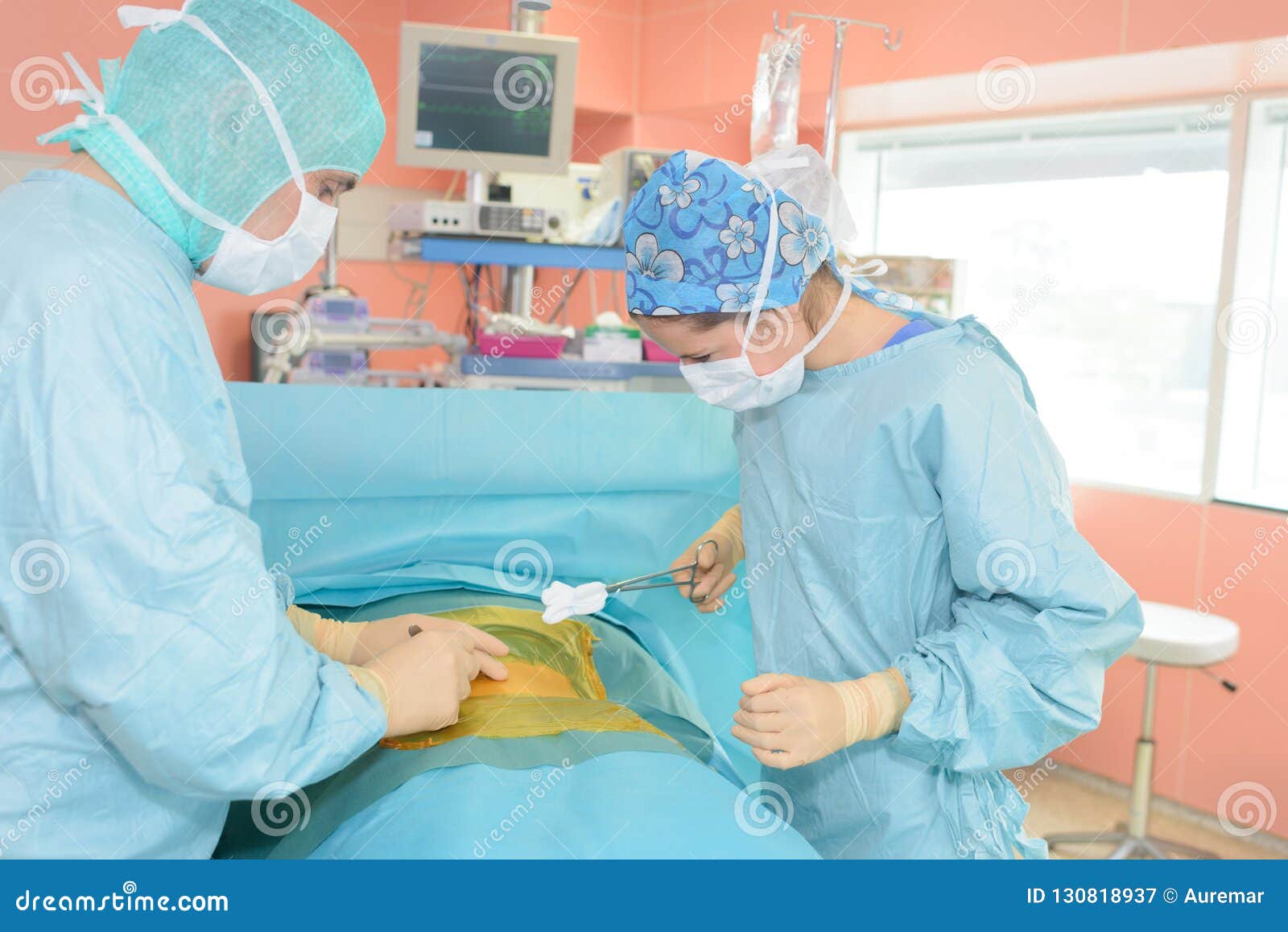 Surgeons in operating room stock image. Image of hands - 130818937