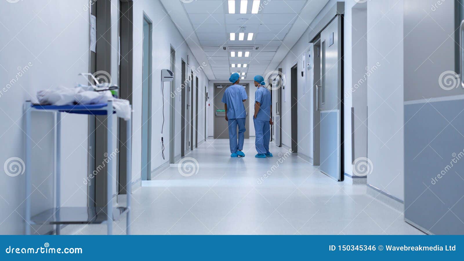 Surgeons Talking with Each Other in the Corridor at Hospital Stock ...