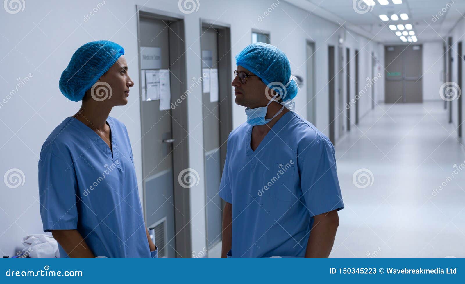 Surgeons Talking with Each Other in the Corridor at Hospital Stock ...