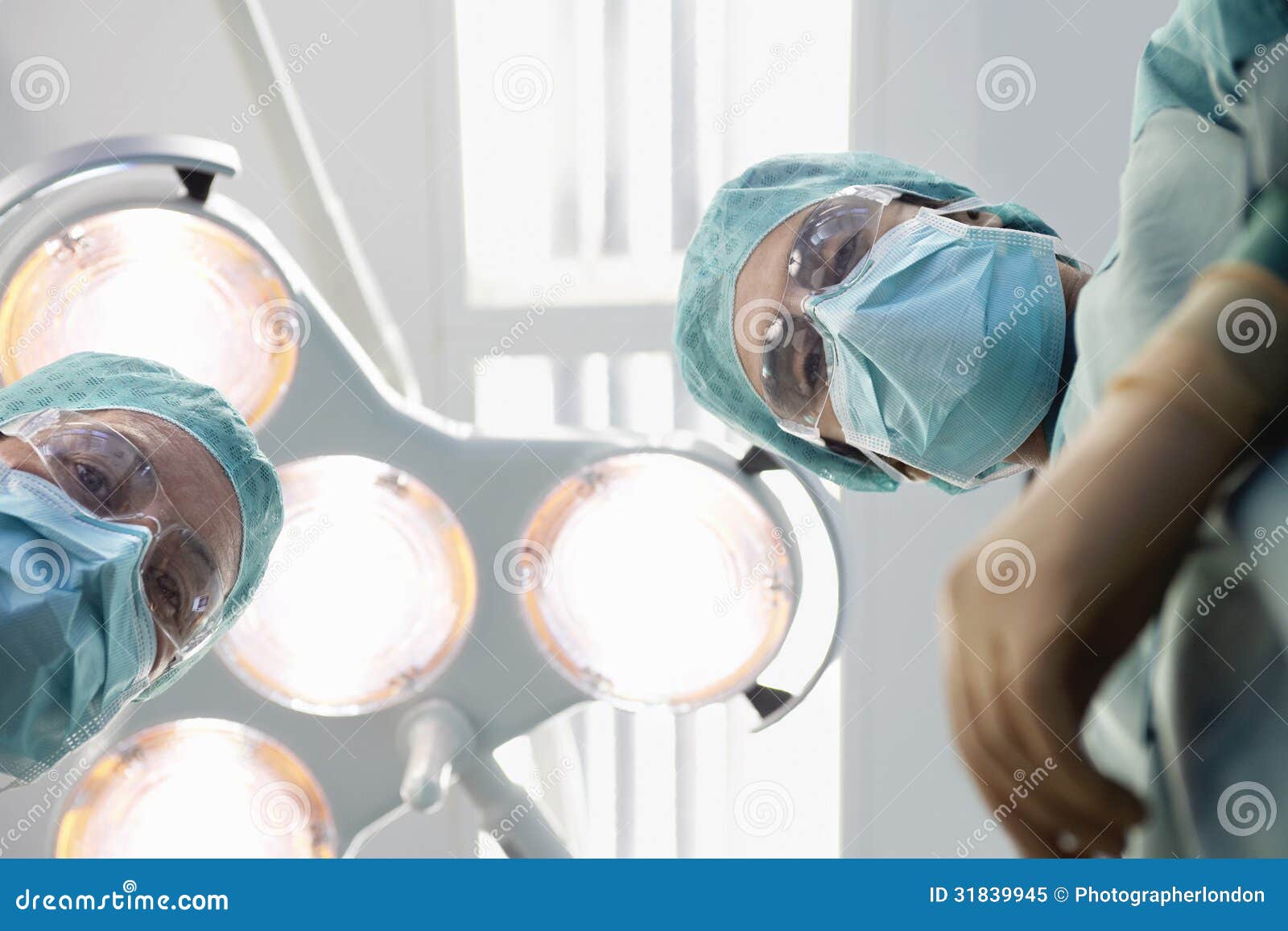 Surgeons Under Surgery Lights in Operating Theatre Stock Image - Image ...