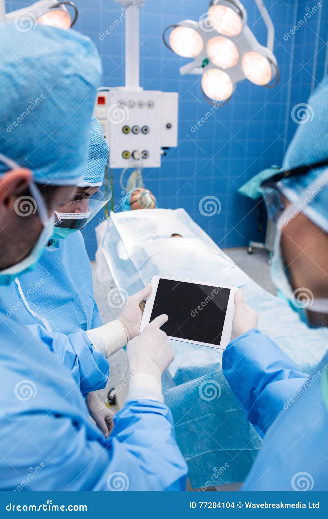 Surgeons Using Digital Tablet and Patient Lying on Operation Bed Stock ...