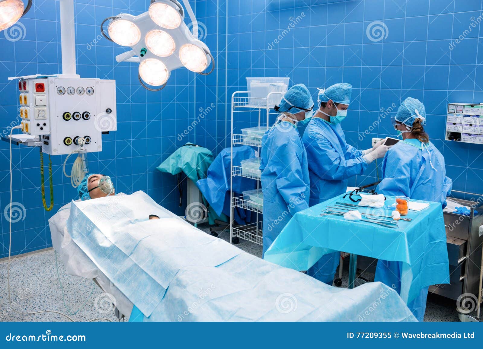 Surgeons Using Digital Tablet and Patient Lying on Operation Bed Stock ...