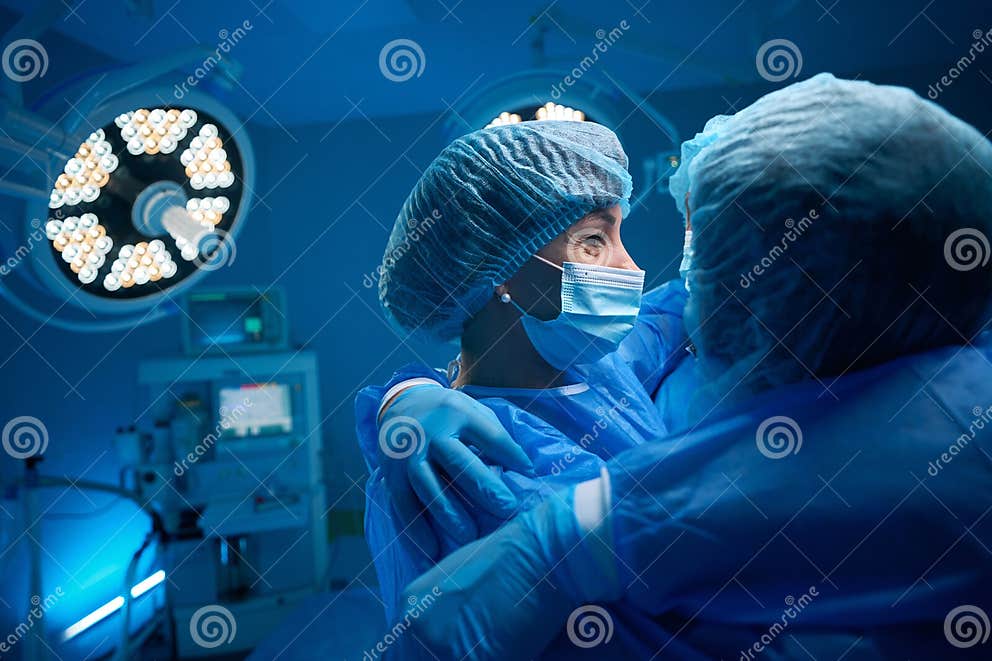 Surgical Doctors Celebrating Successful Operation and Hugging Stock ... Surgical Doctors Celebrating Successful Operation and Hugging Stock ...