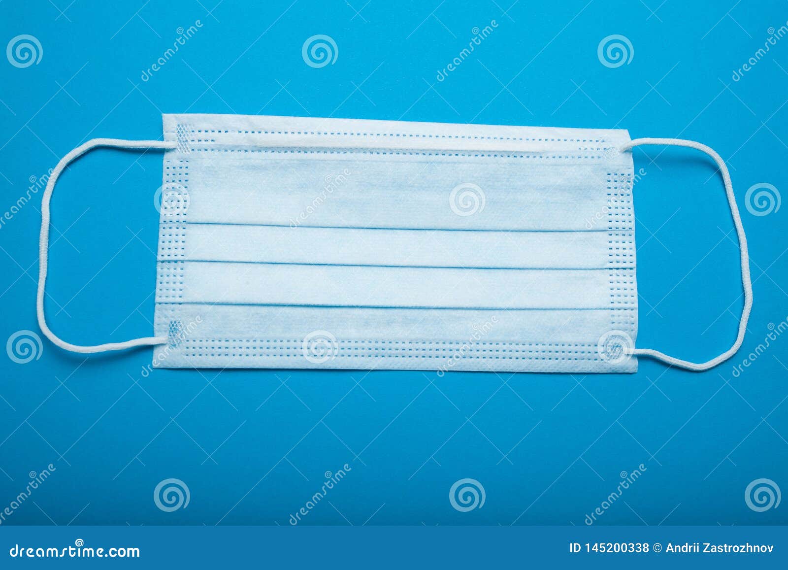 Surgical Ear-Loop Mask on Blue Background, Concept Stock Photo - Image ...