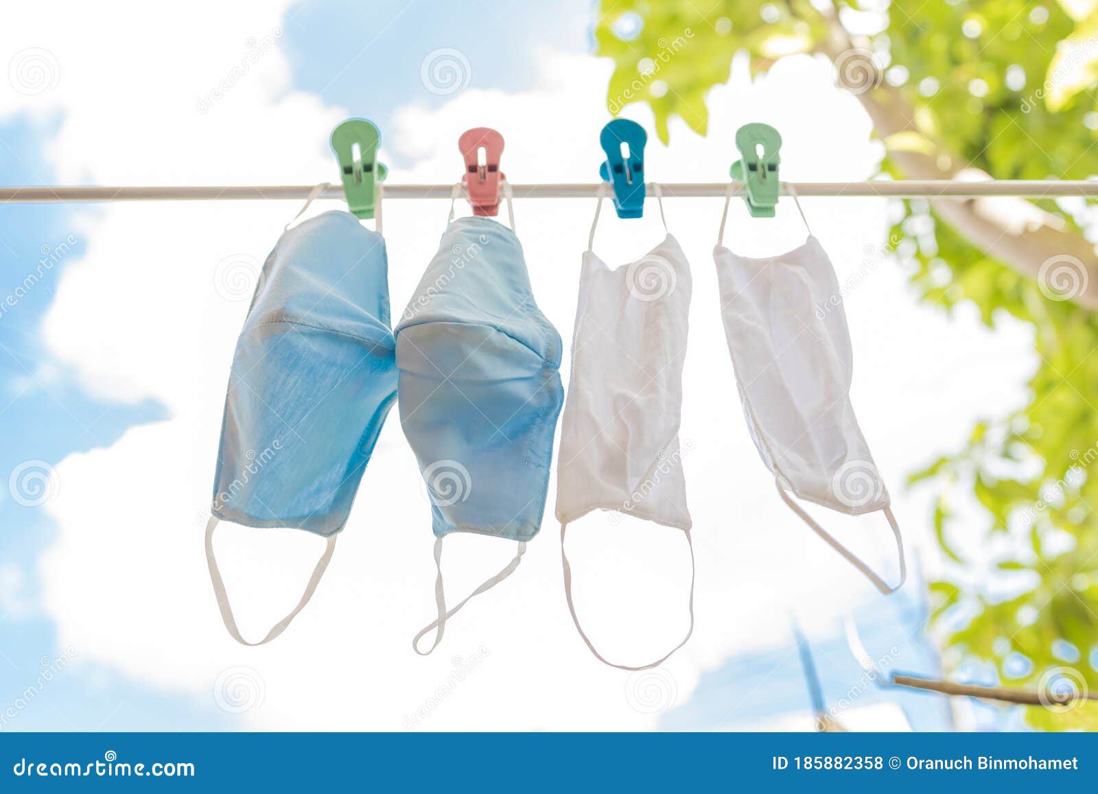 Surgical Face Masks Drying in Sun on a Rope with Blue Sky in Background ...