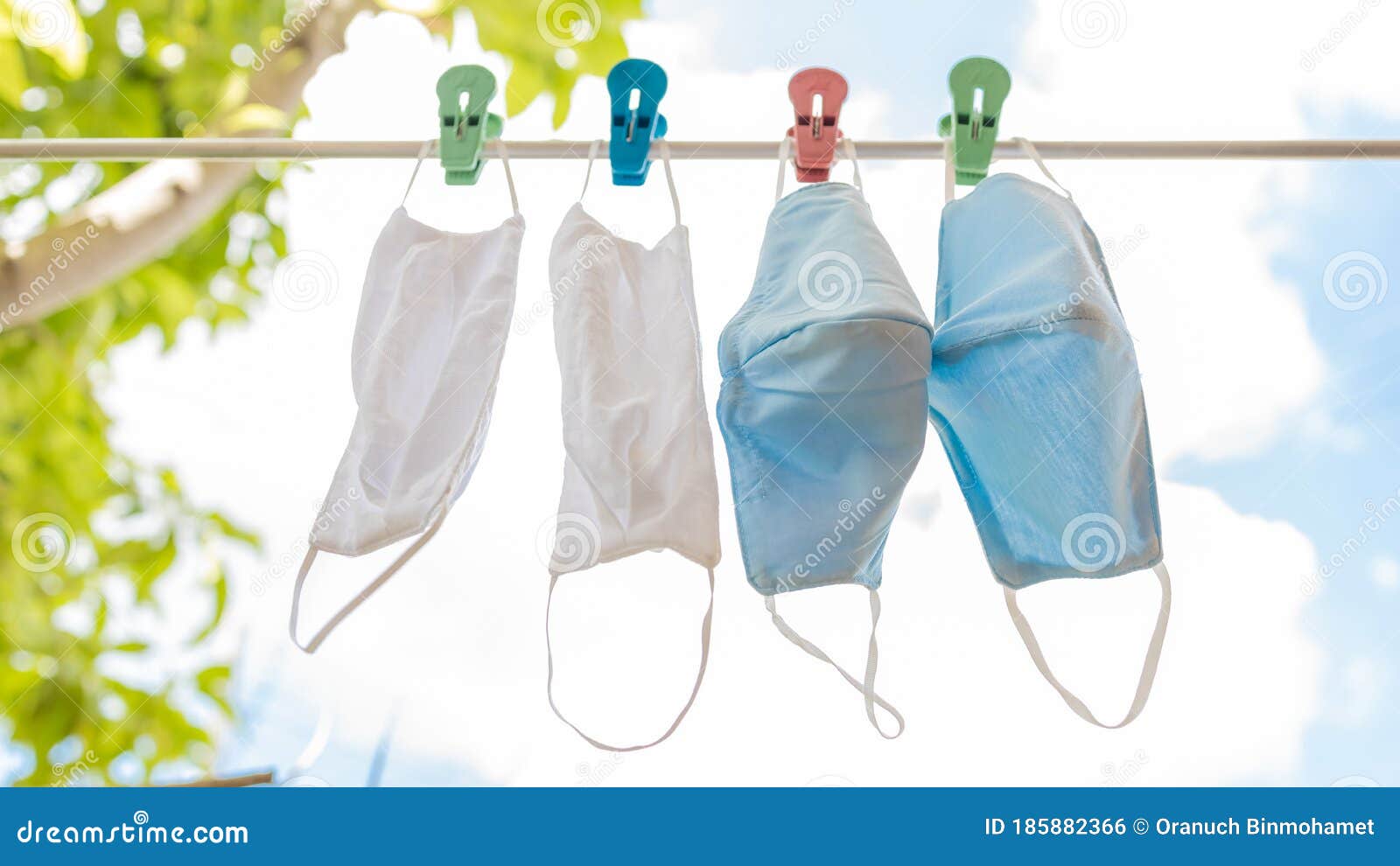 Surgical Face Masks Drying in Sun on a Rope with Blue Sky in Background ...