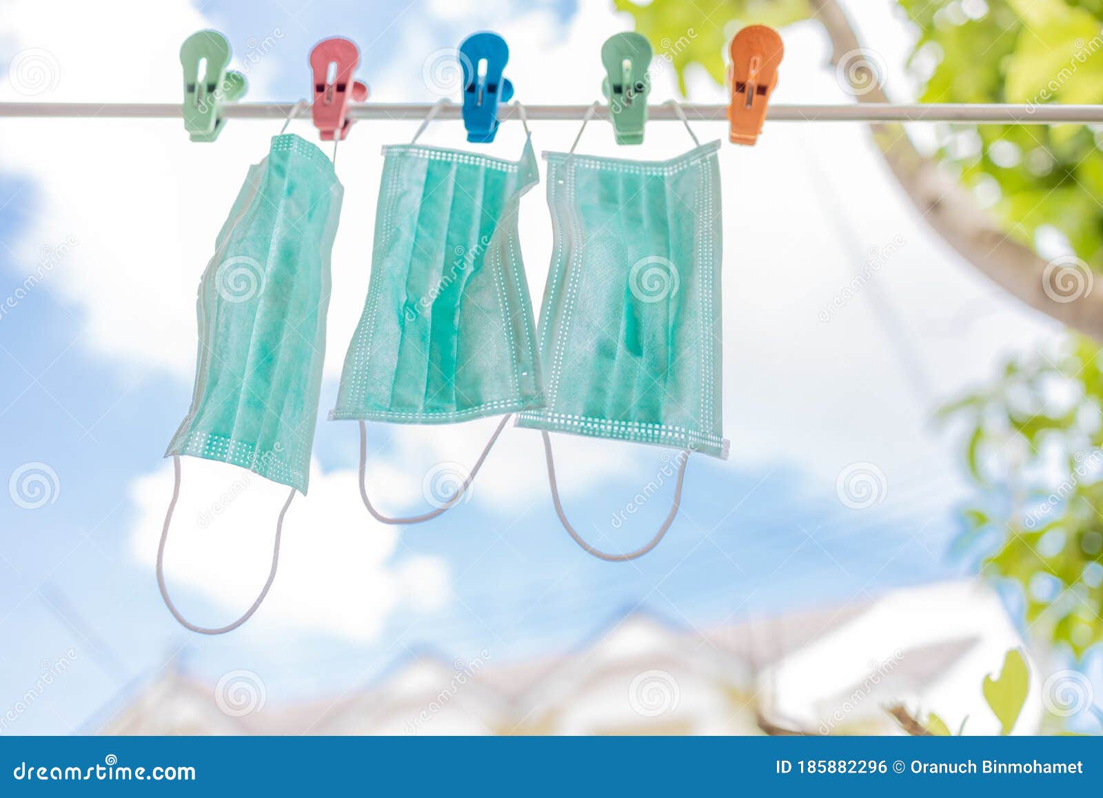 Surgical Face Masks Drying in Sun on a Rope with Blue Sky in Background ...