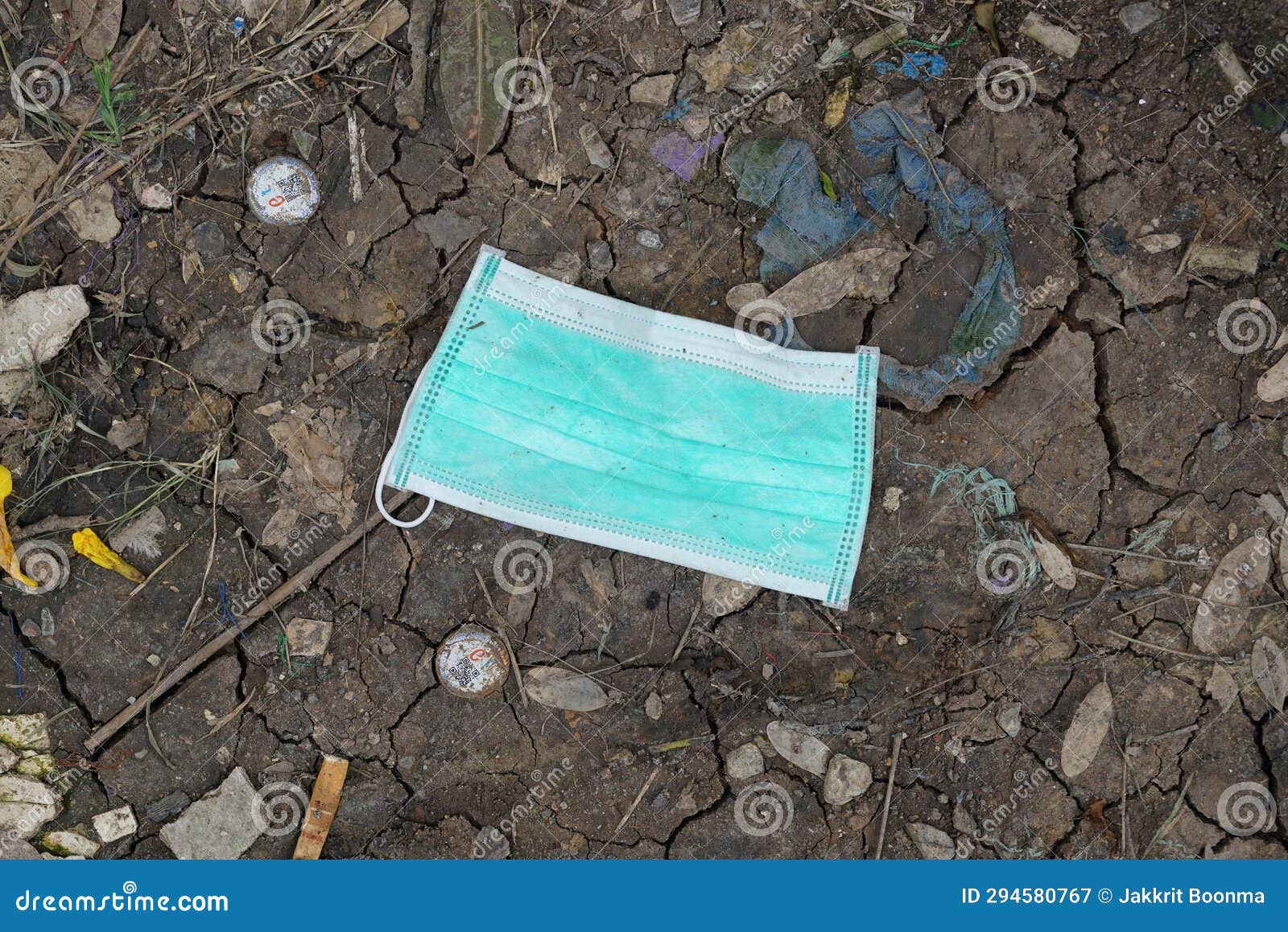 A Surgical Mask on the Ground, Pollution of the Environment Concepts ...