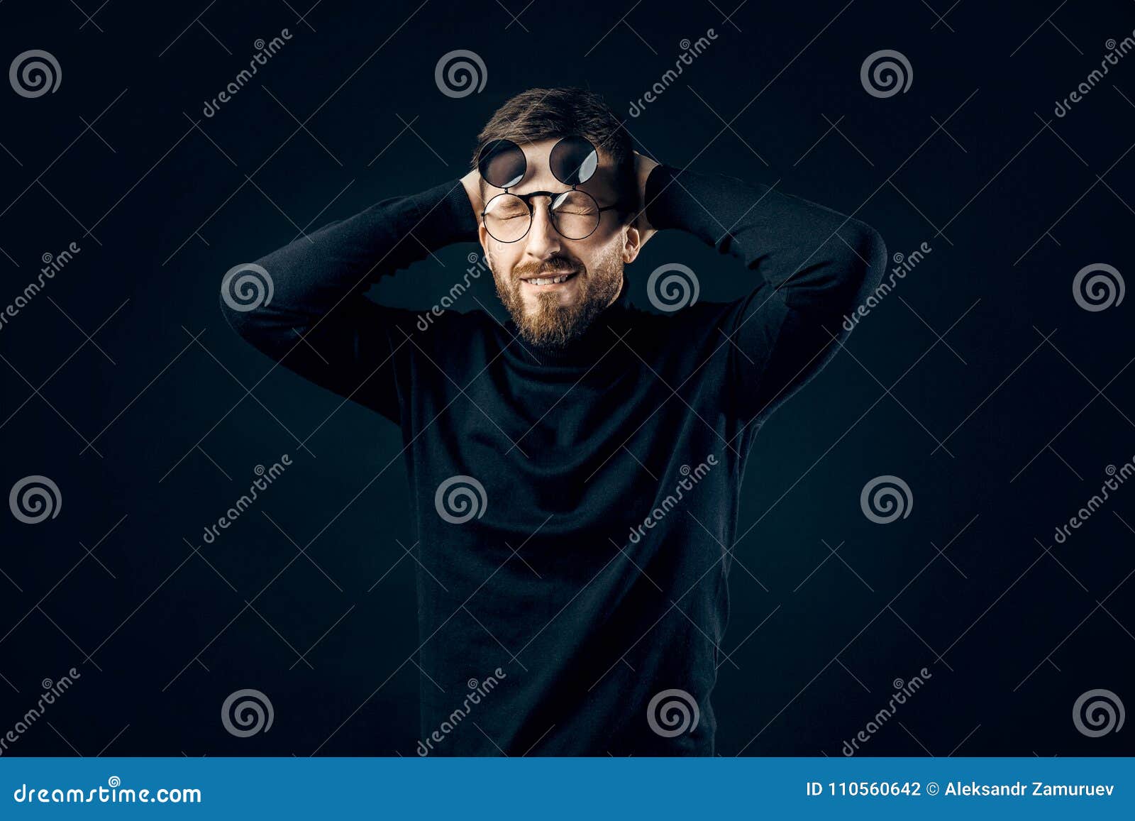 Surprised Bearded Man In Black Rounded Glasses Holding His Head Stock
