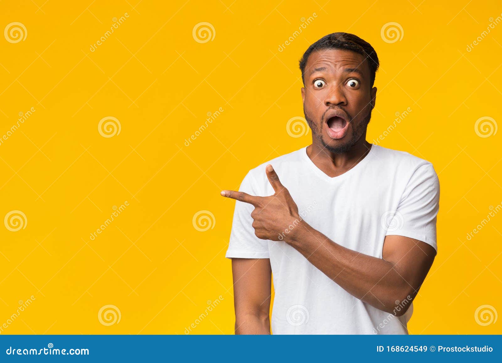 Surprised Black Man Pointing Finger Aside Standing in Studio Stock ... Surprised Black Man Pointing Finger Aside Standing in Studio Stock ...