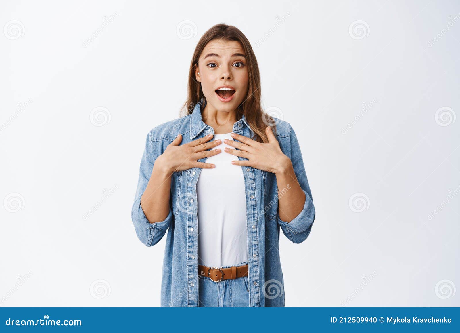 Surprised Blond Girl Gasping Amazed And Holding Hands On Chest Staring