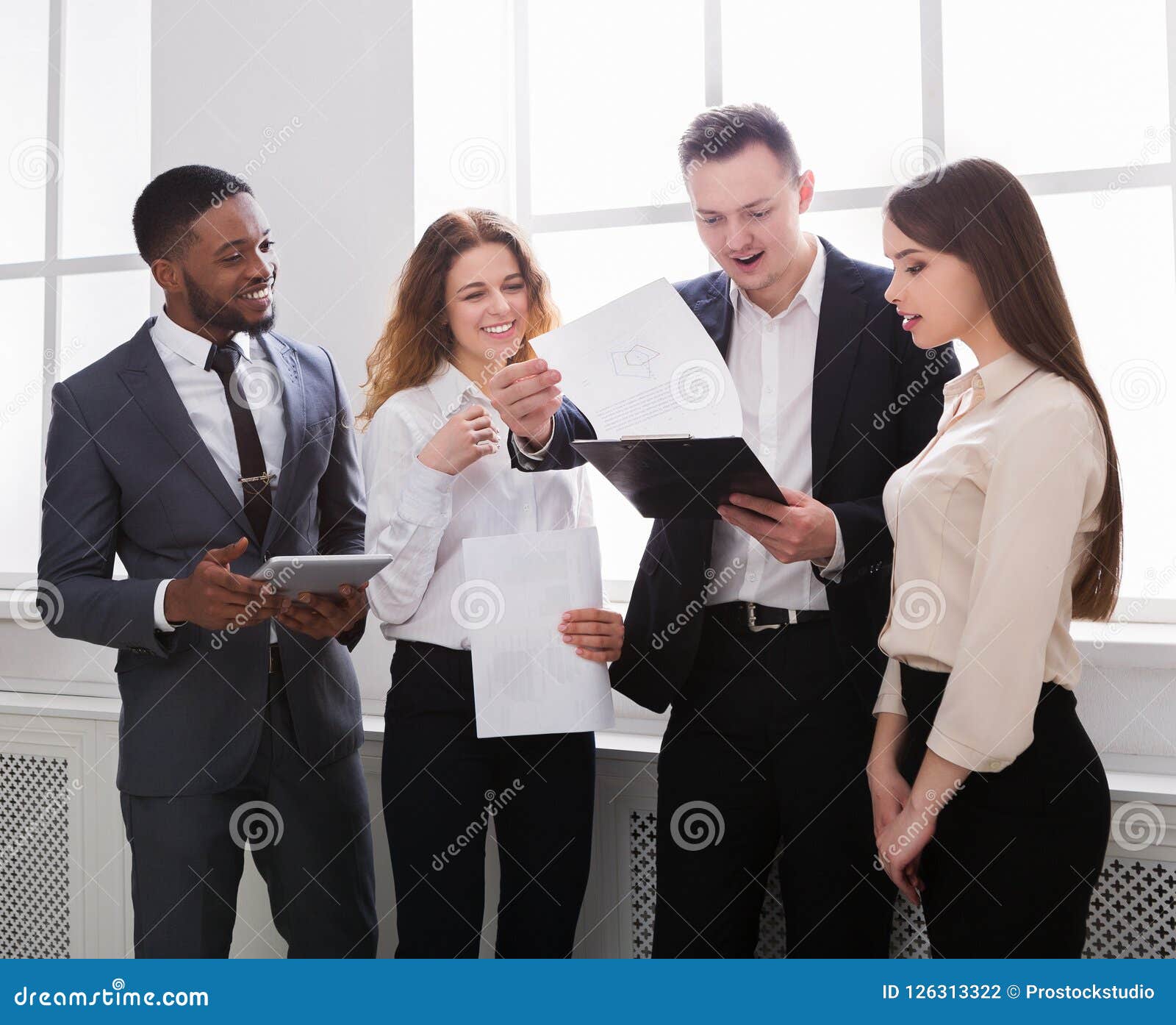 Surprised Business Team Looking at Documents in Office Stock Photo ...
