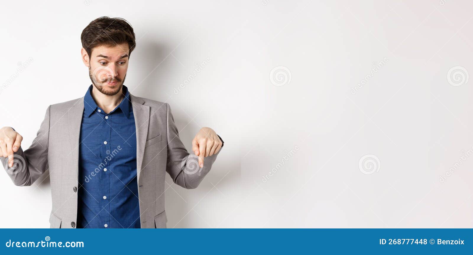 Surprised Businessman Looking and Pointing Down with Raised Eyebrows ...