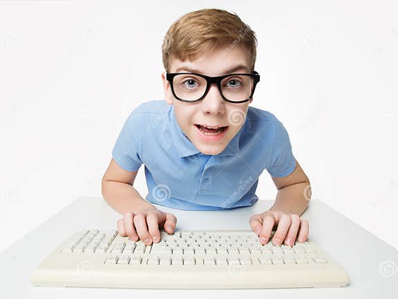 Surprised Child Using Computer Keyboard. Teenage Boy Hacker Typing on ...