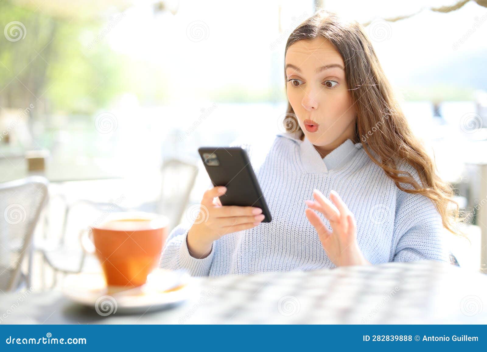 Surprised Coffee Shop Customer Checking Phone Stock Photo - Image of ...