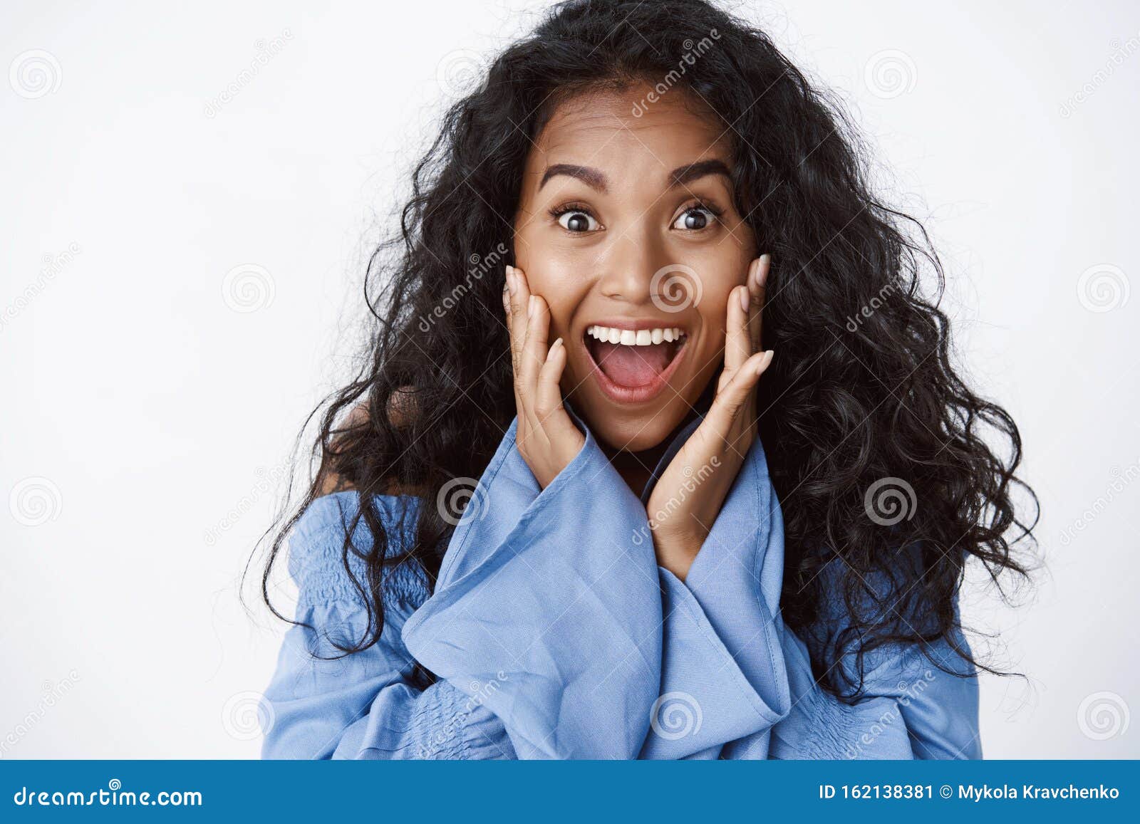 Surprised And Glad Enthusiastic African American Curly Haired Woman In