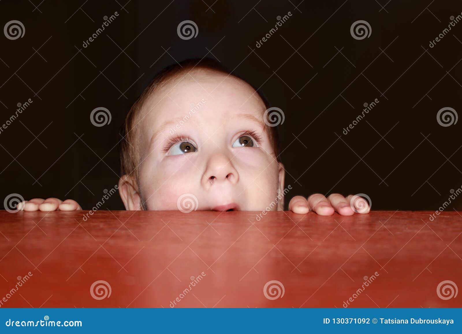 Surprised Little Boy Peeking from a Table Stock Photo - Image of ...
