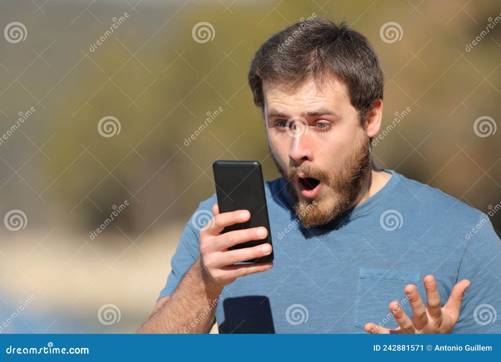 Surprised Man Checking Smart Phone Content Outside Stock Image - Image ...