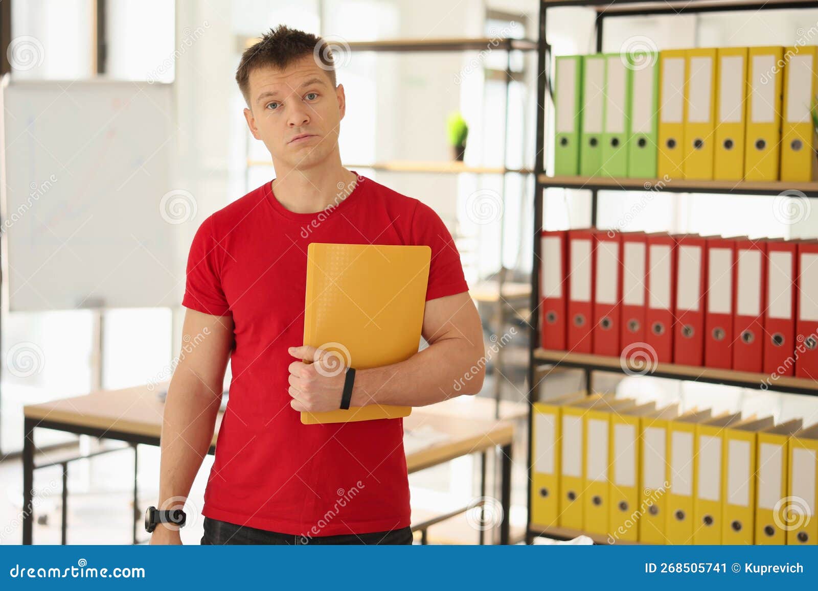 Surprised Man with Documents in Hands in Office with Bookshelves and ...