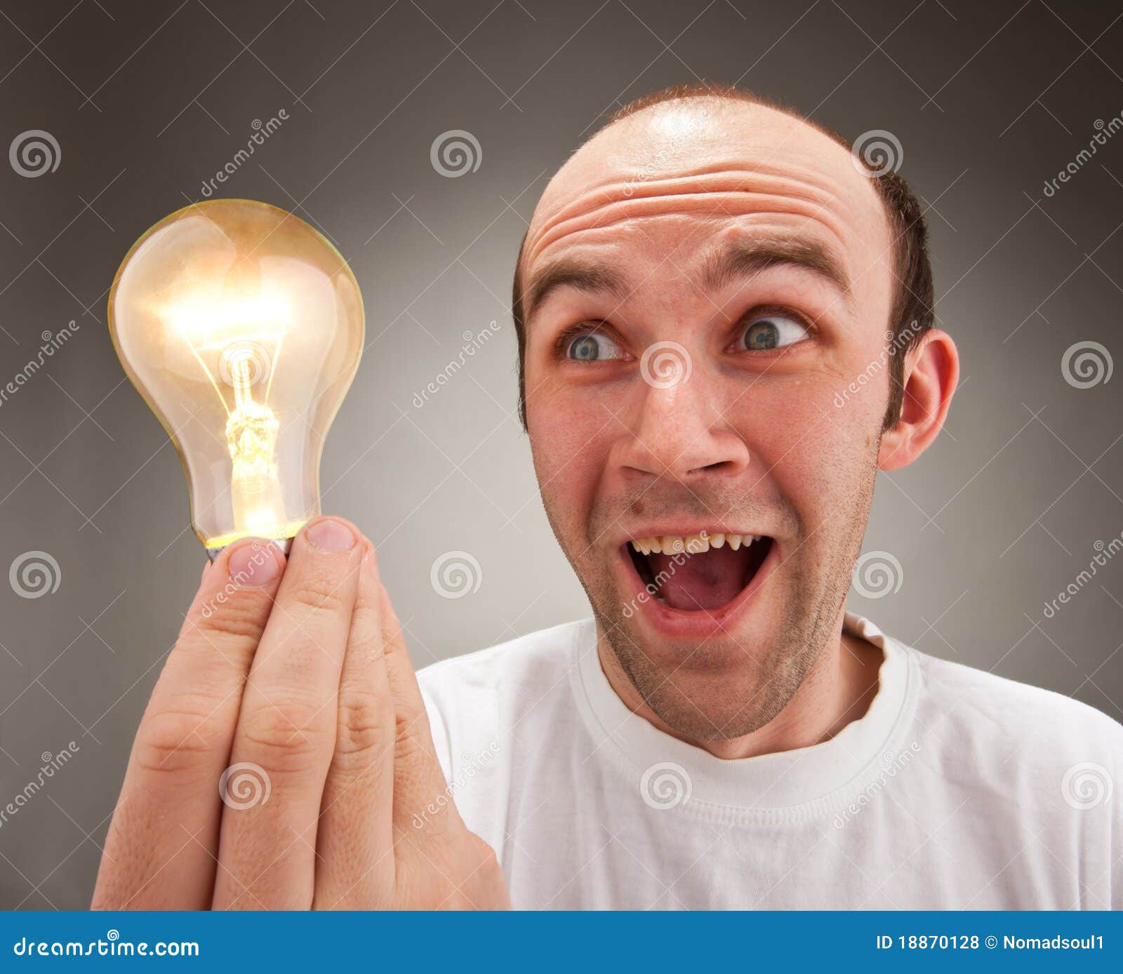 Surprised Man Holding Lighting Bulb Stock Photo - Image of innovation ...