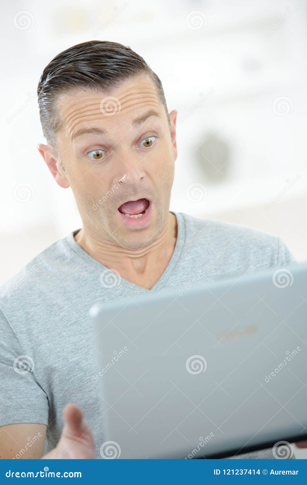 Surprised Man Looking into Computer Screen Stock Photo - Image of ...