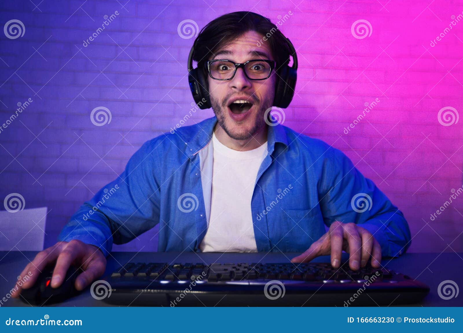 Surprised Man Playing Online Computer Game, Wearing Headset Stock Photo ...