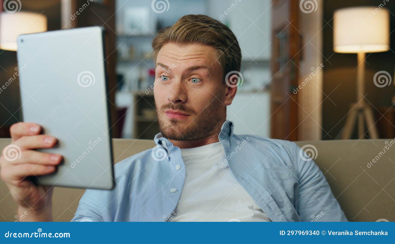 Surprised Man Reading Tablet Screen at House Closeup. Wondering Guy ...