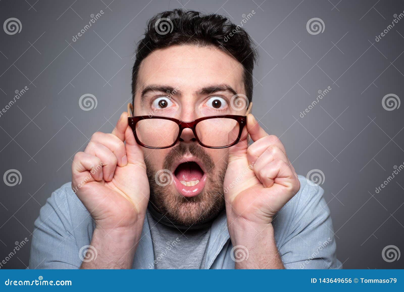 Surprised Man Touching Glasses Feeling Shocked Stock Photo - Image of ...