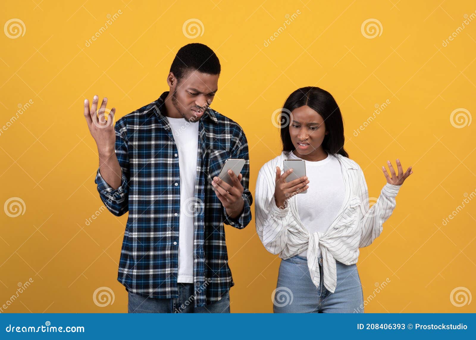 Surprised Sad Millennial African American Couple Looking At Phones With