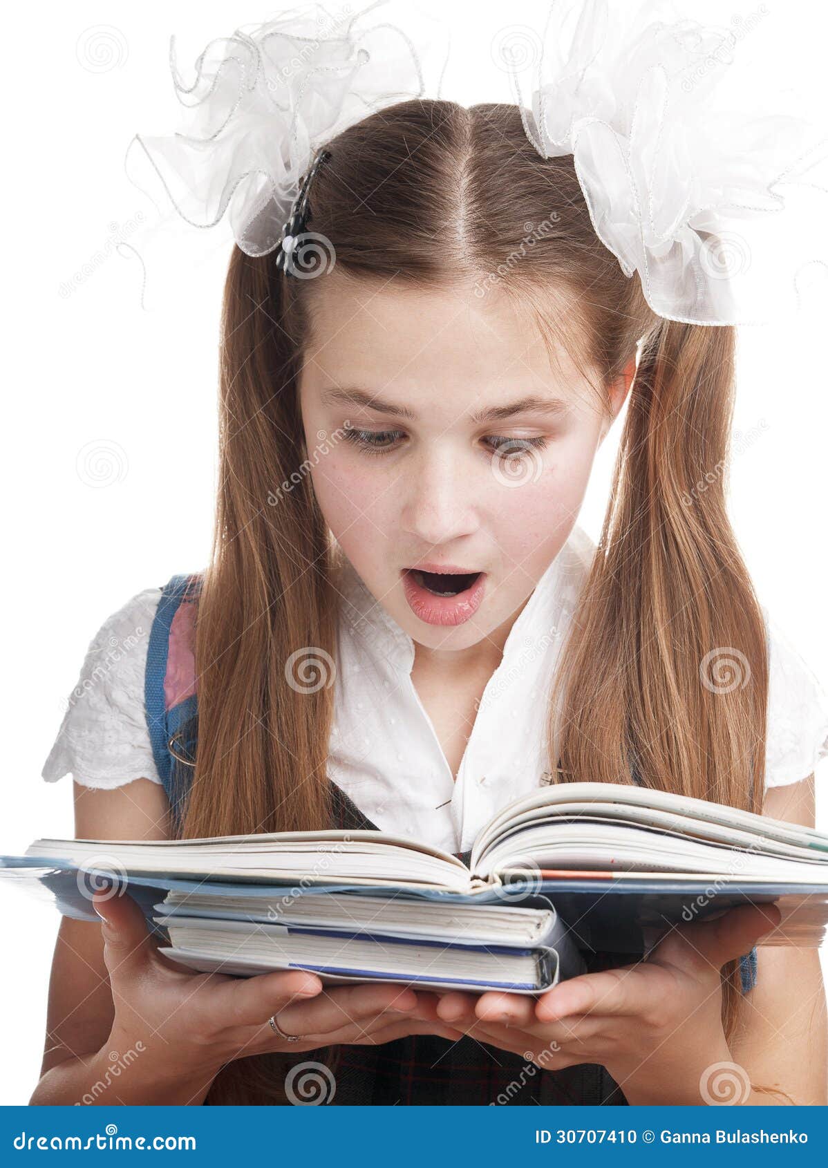 Surprised Schoolgirl Reading Textbook. Stock Photo - Image of ...
