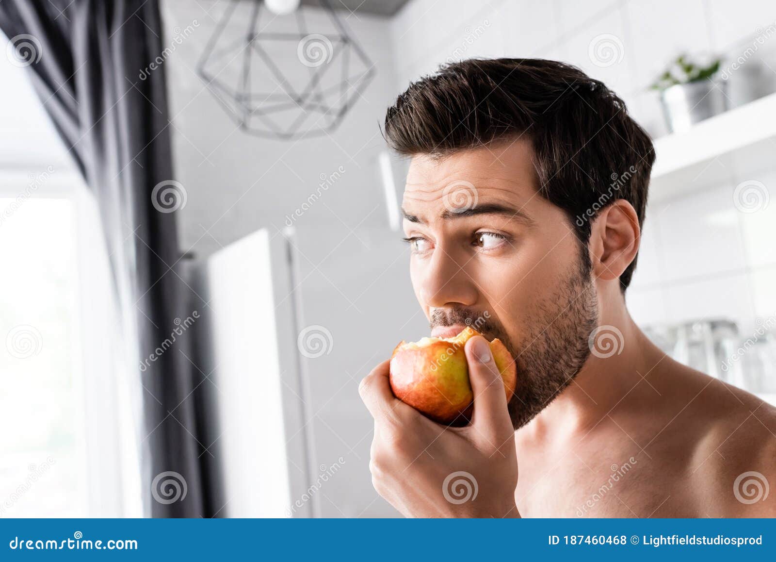 Surprised Shirtless Man Eating Apple on Stock Photo - Image of ...