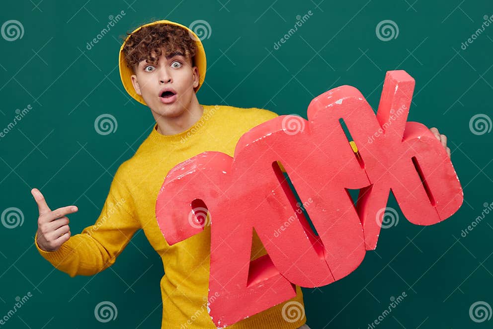 A Surprised Shocked Man Stands On A Green Background In Bright Clothes