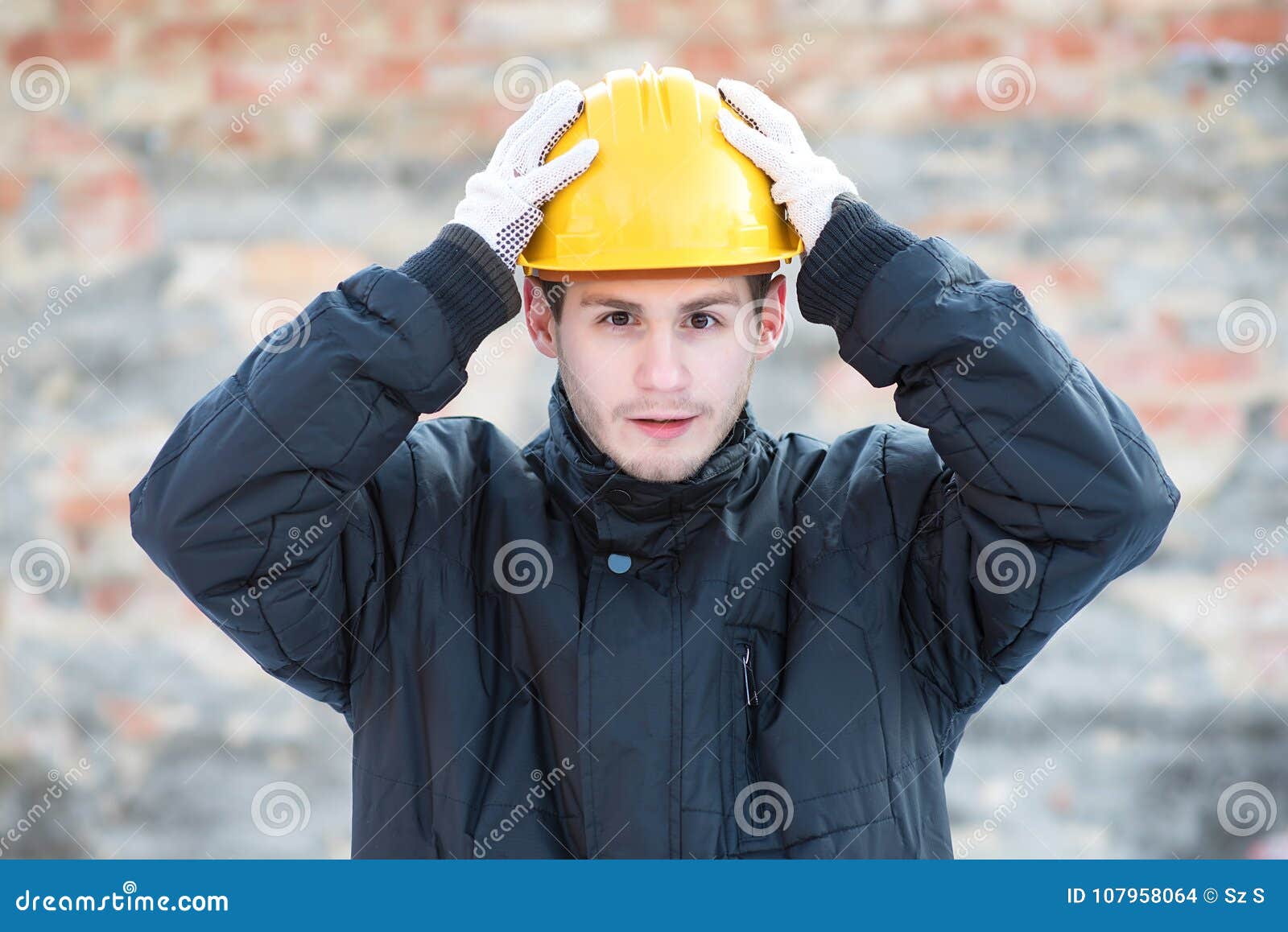 Surprised Worker In His 50s With Helmet Standing Outside And Holding A ...
