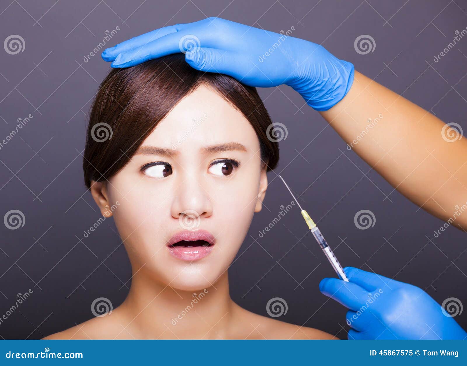Surprised Young Woman Looking at Needle for Injection into Face Stock ...