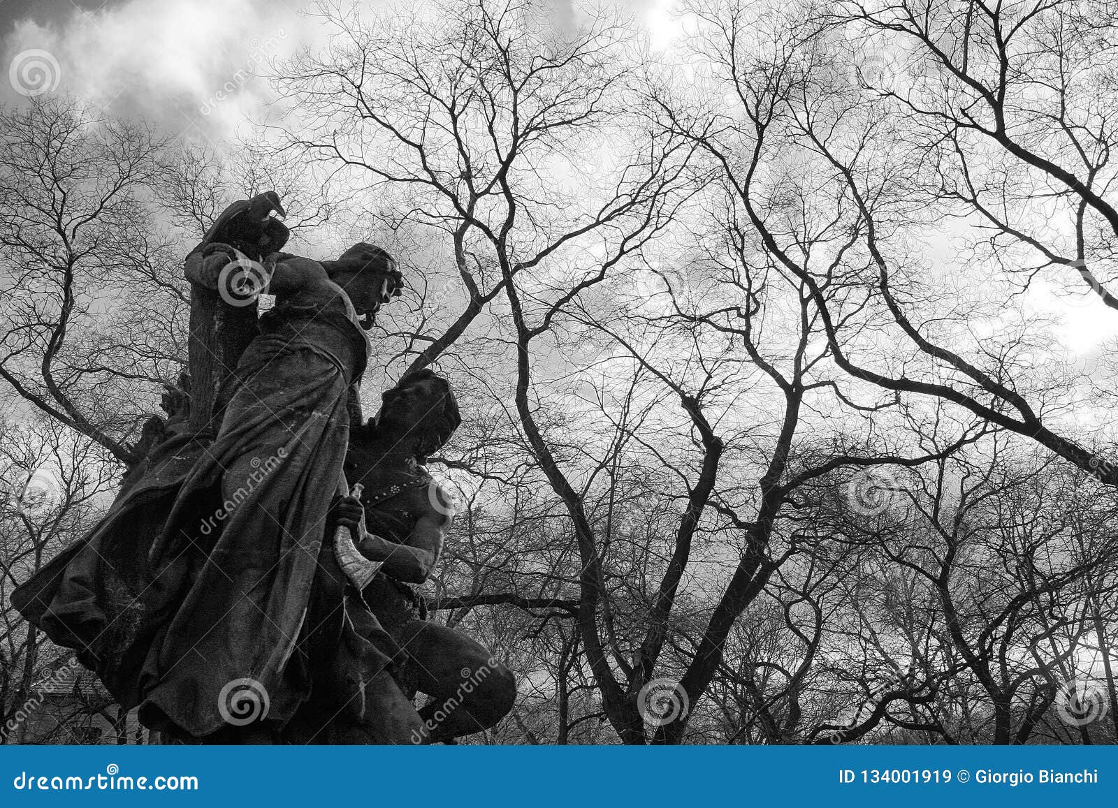 Surrounded by a Crown of Bare Branches of Trees, a Sculpture ...