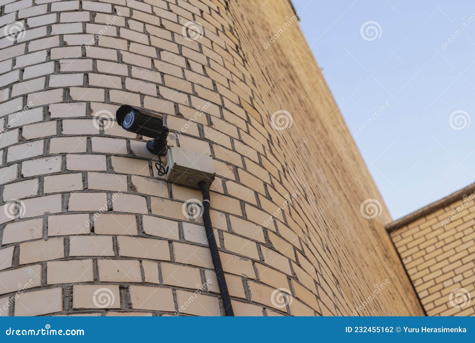 Surveillance Camera on the Facade of a Residential Brick Building ...
