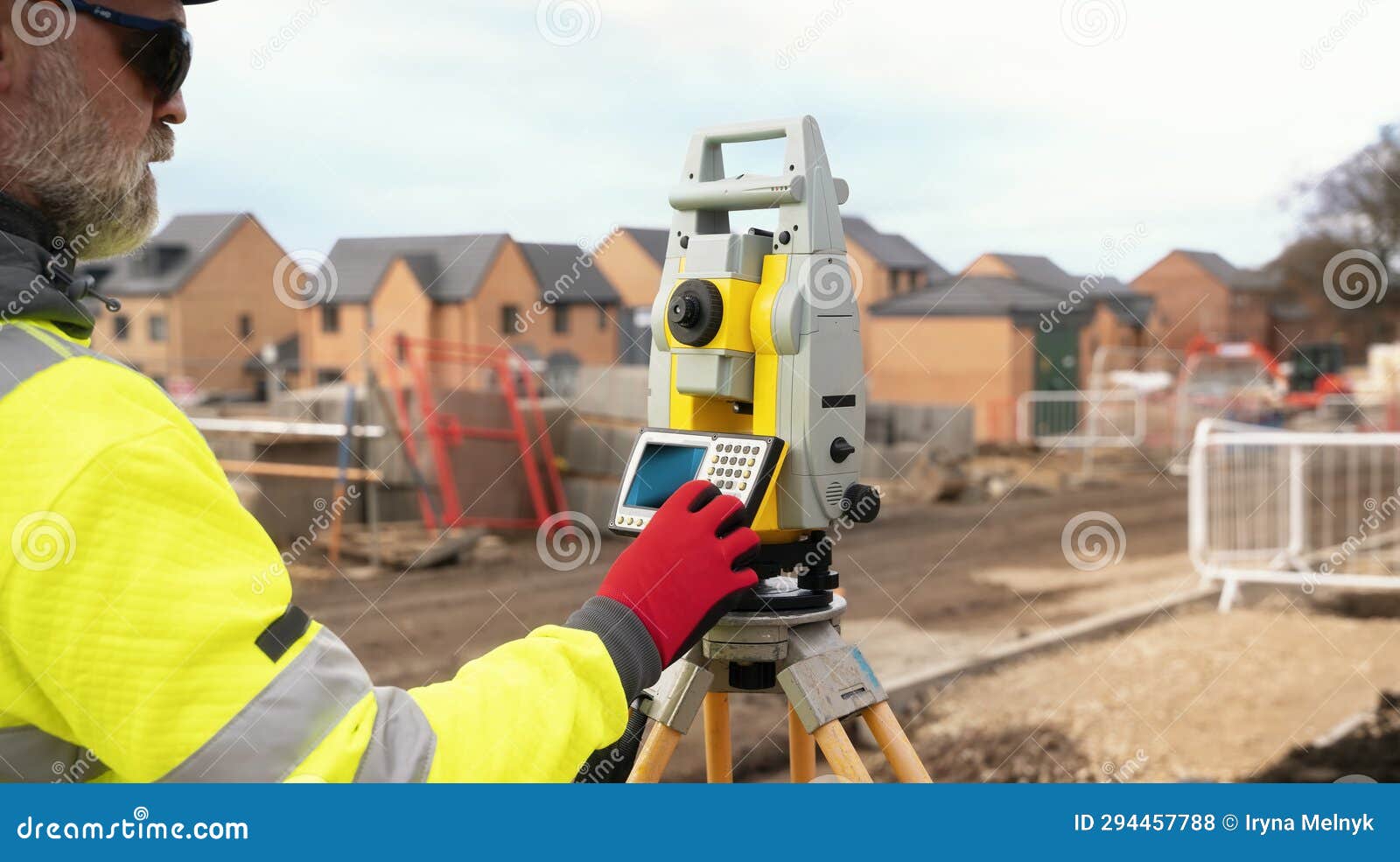 Surveyor Builder Site Engineer with Theodolite Total Station at Construction Site Outdoors ...
