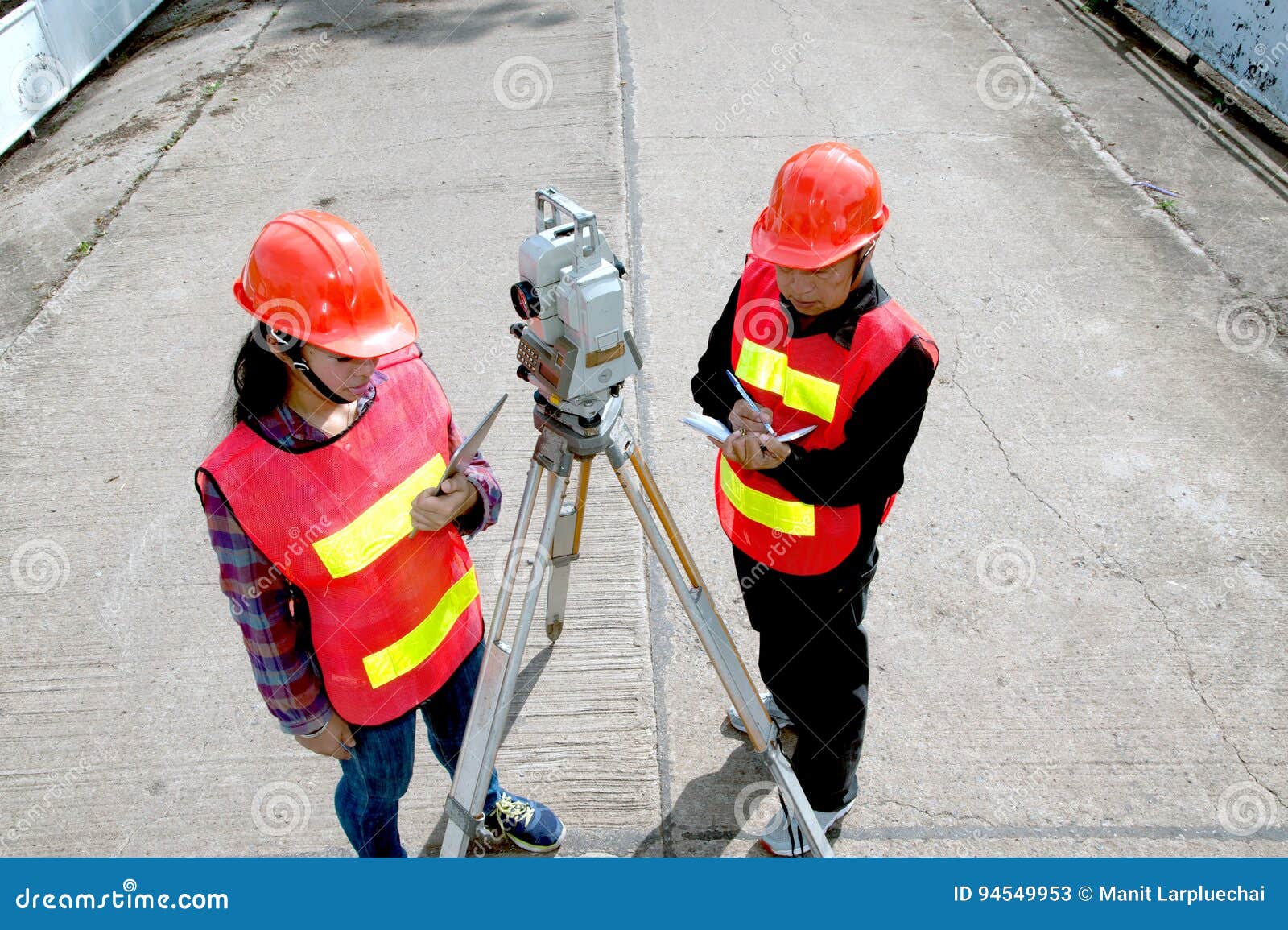 Surveyor or Engineer Making Measure with Partner on the Field. Stock ... Surveyor or Engineer Making Measure with Partner on the Field. Stock ...