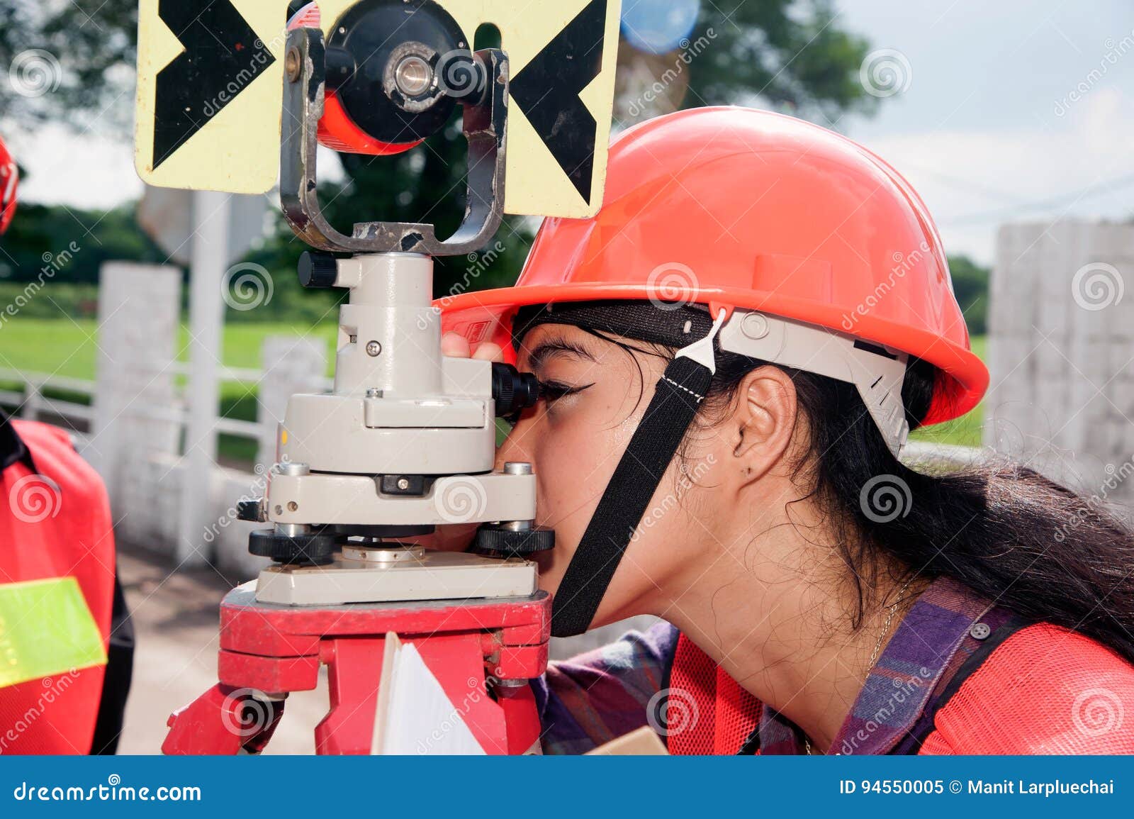 Surveyor or Engineer Setting Prism Reflector with Partner on the Field ...